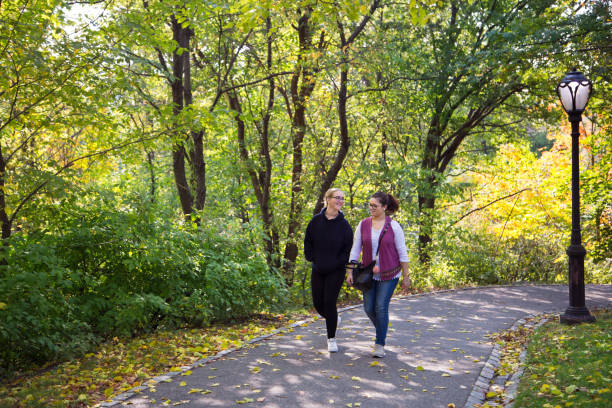 Free Stock Photo of Two People Walking Down a Path in a Park | Download ...
