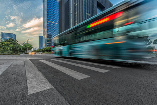 Free Stock Photo of Bus Driving Down Street Next to Tall Buildings ...