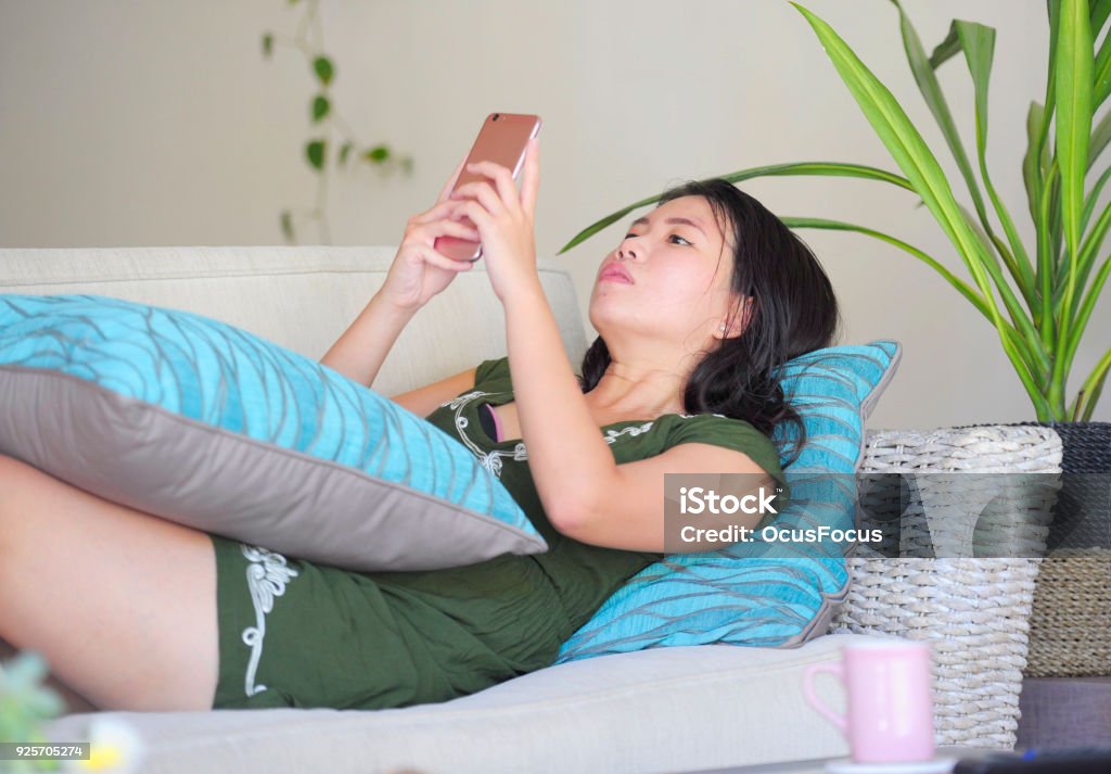 Young Beautiful And Relaxed Asian Chinese Woman Lying At Home Living