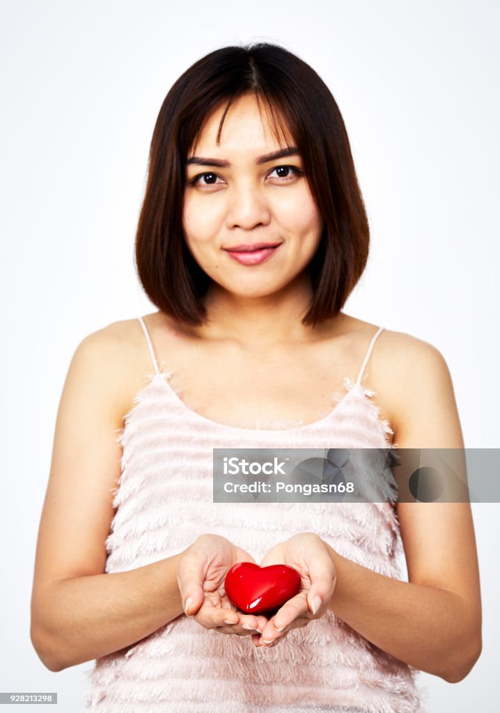 Portrait Of Beautiful Asian Young Woman Holding Red Heart