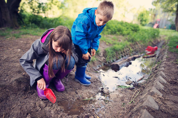 Free Stock Photo of Young children playing in puddle mud together ...