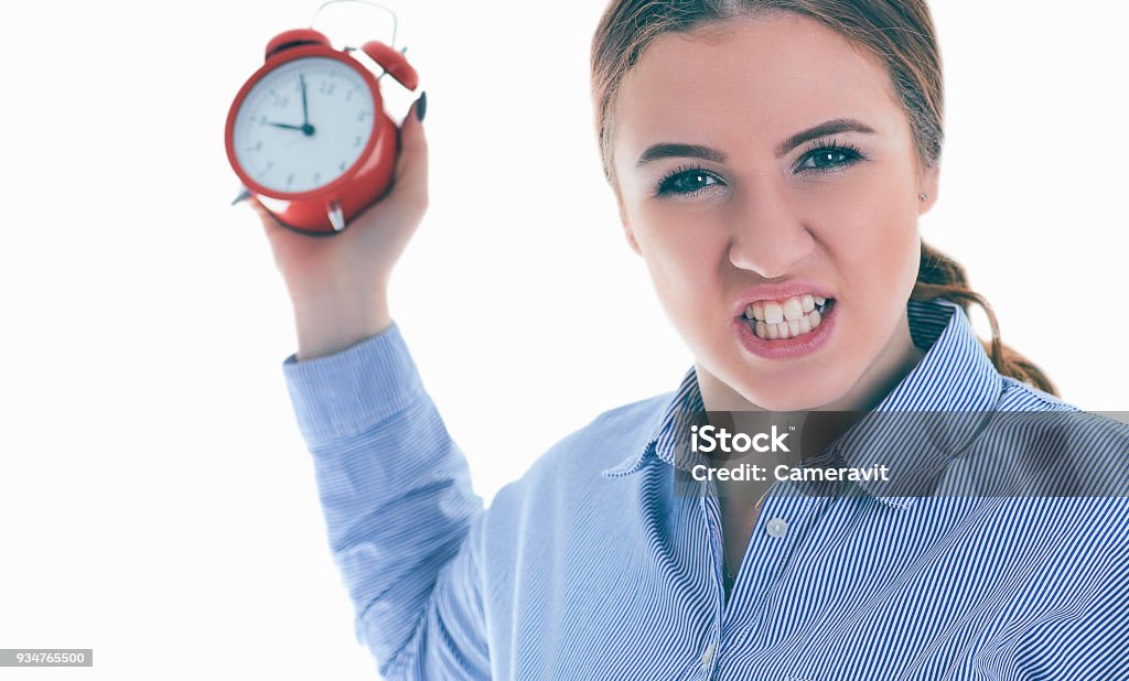 Angry Young Caucasian Woman Throwing An Alarm Clock Isolated In White ... Angry Young Caucasian Woman Throwing An Alarm Clock Isolated In White ...