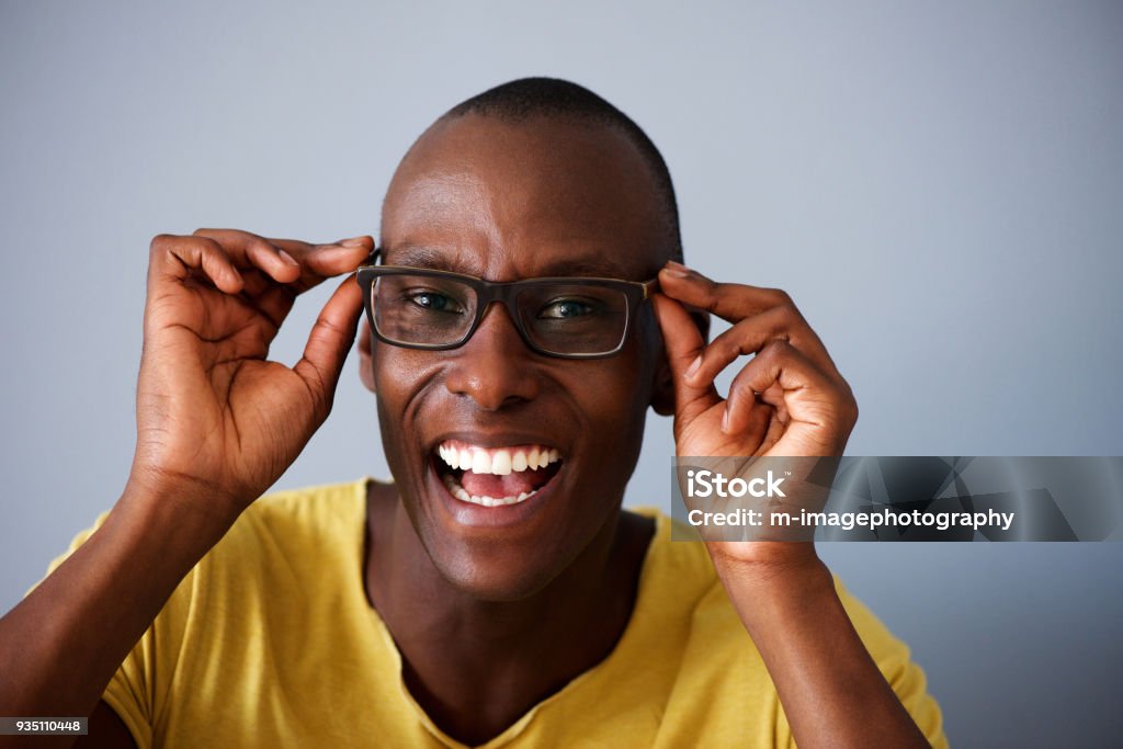 Close Up Happy African American Man Smiling With Glasses Against Gray