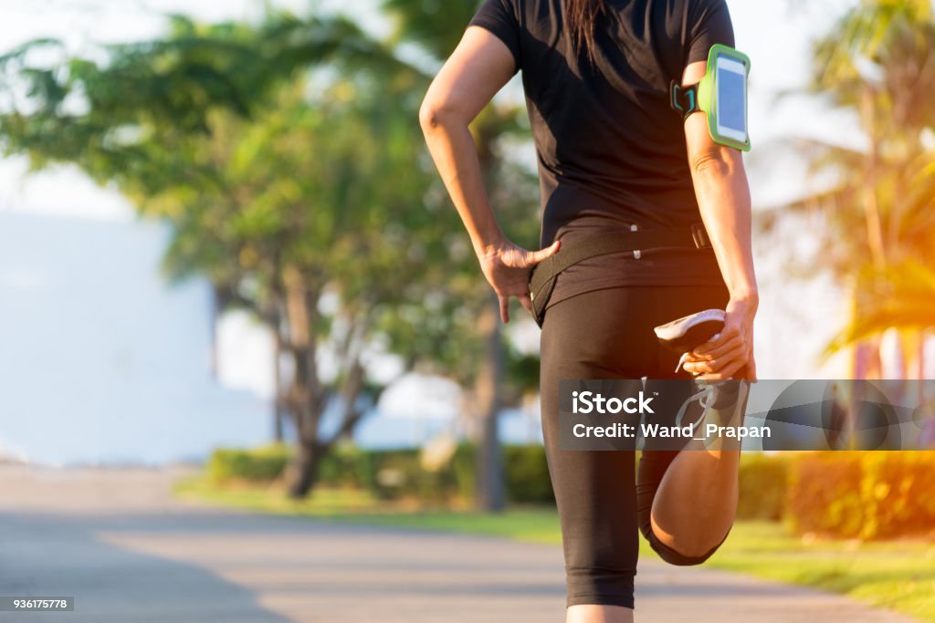Healthy Life Asian Fitness Woman Runner Stretching Legs Before Run