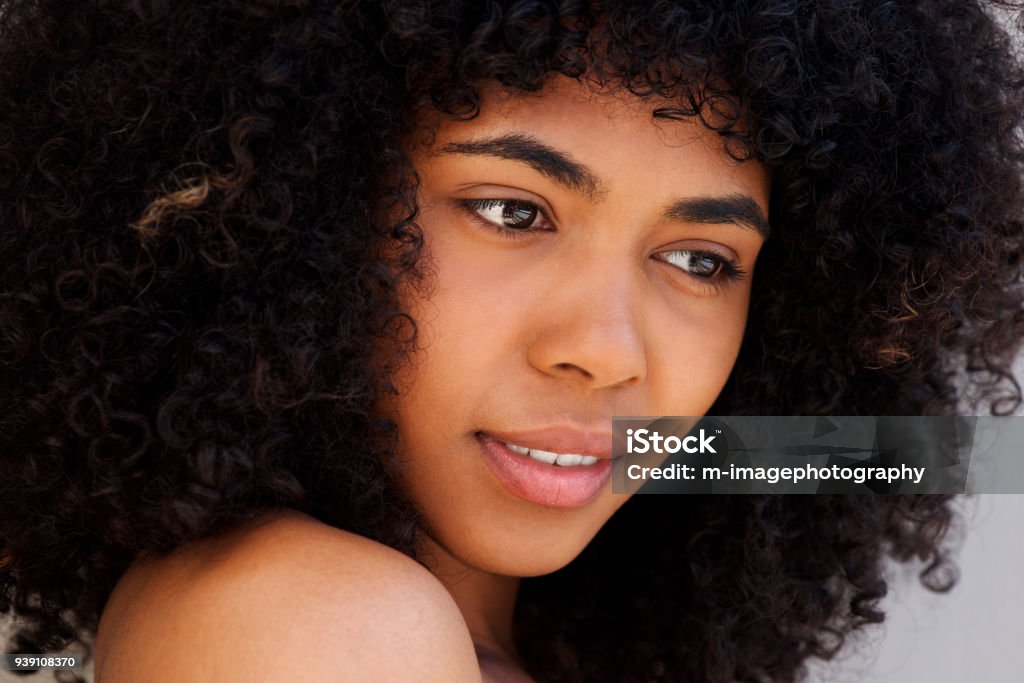 Close Up Young African American Woman With Curly Hair Looking Away
