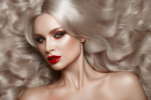 Beautiful Blonde In A Hollywood Manner With Curls Natural Makeup And