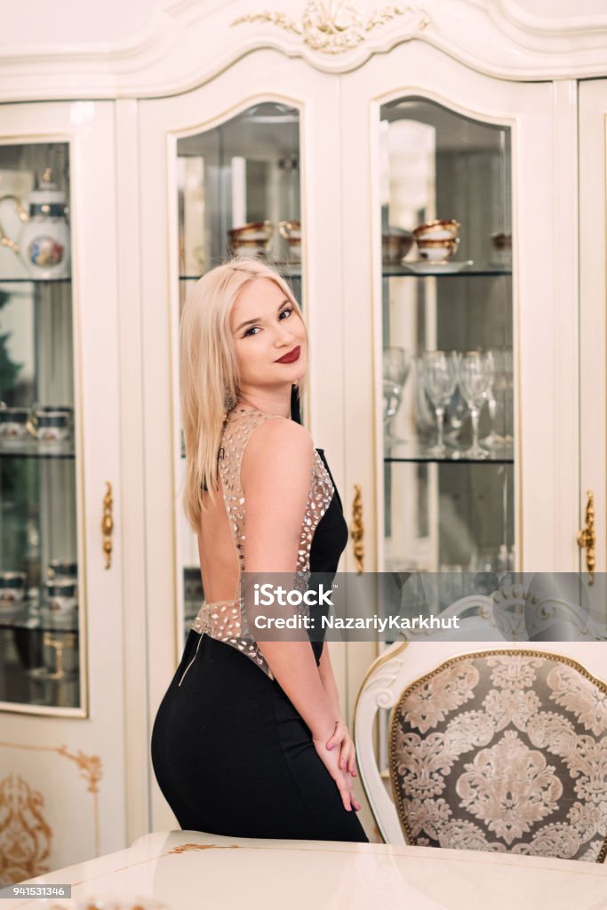 Stylish Elegant Blonde Woman In Beauty Rich Interior Wearing Black
