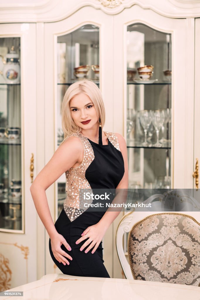 Stylish Elegant Blonde Woman In Beauty Rich Interior Wearing Black