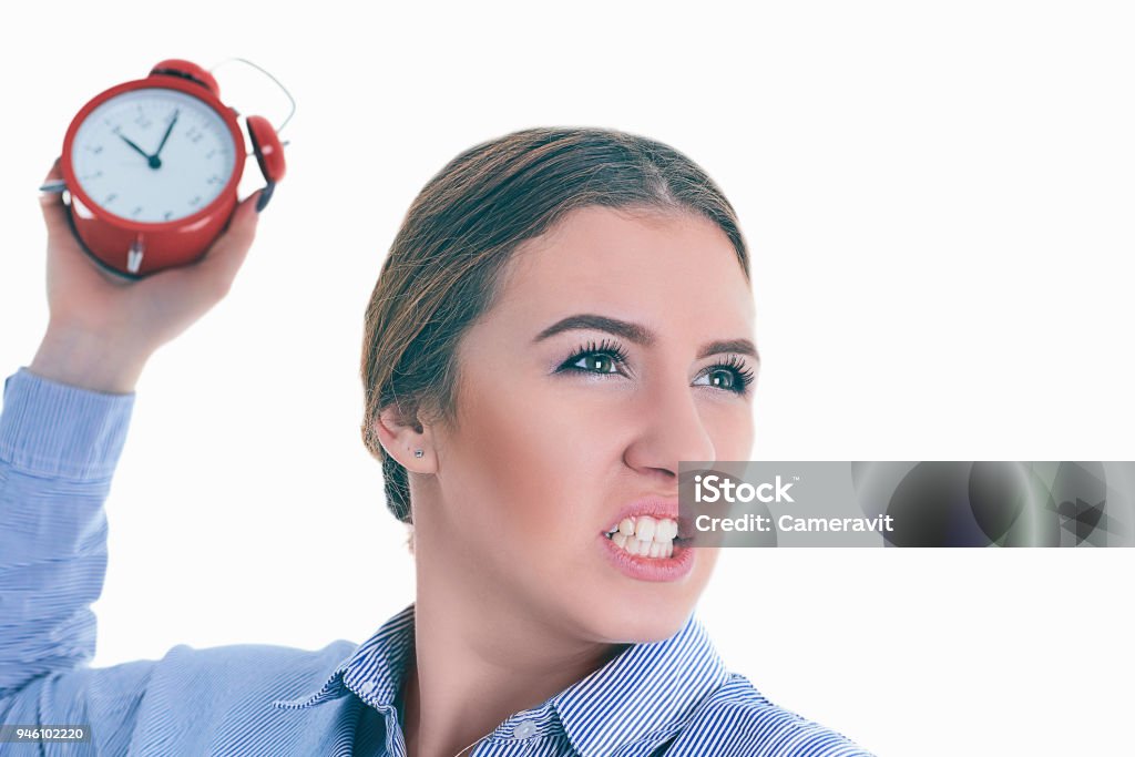 Angry Young Caucasian Woman Throwing An Alarm Clock Isolated In White ... Angry Young Caucasian Woman Throwing An Alarm Clock Isolated In White ...