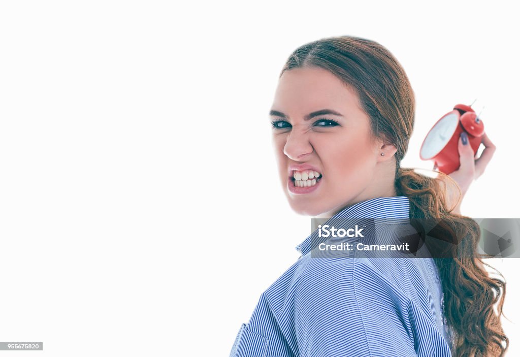 Angry Young Caucasian Woman Throwing An Alarm Clock Isolated In White ... Angry Young Caucasian Woman Throwing An Alarm Clock Isolated In White ...
