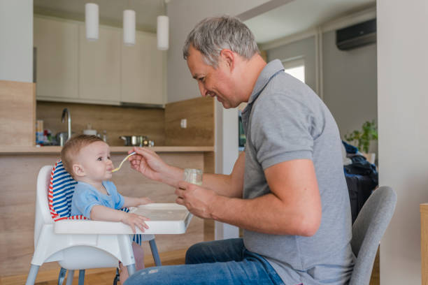 Free Stock Photo of Dad feeding his distracted son | Download Free ...