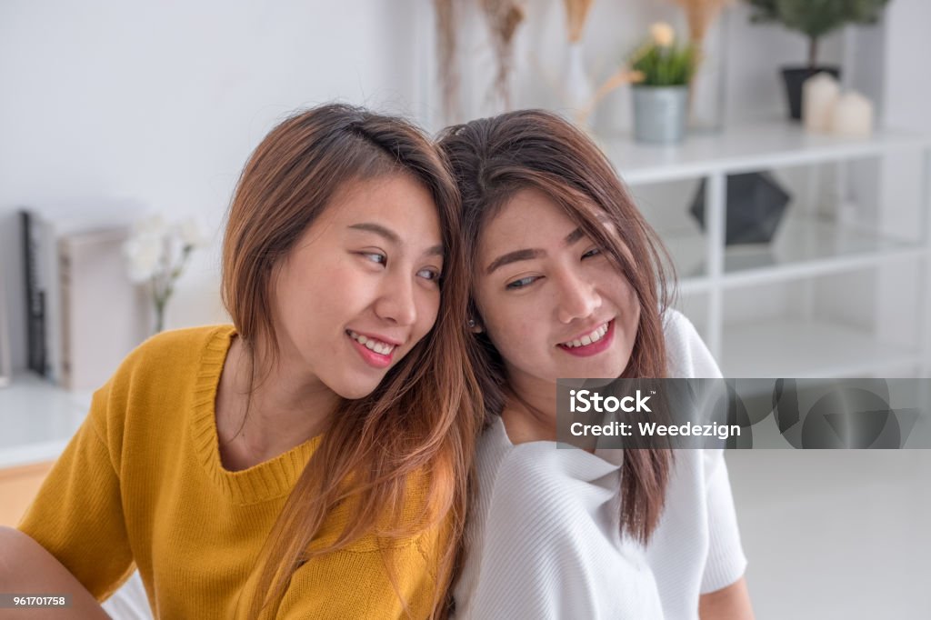 Asia Lesbian Lgbt Couple Hug And Sitting On Bed Near White Window