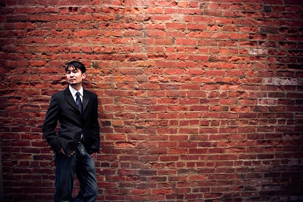 Free Stock Photo of Man leaning against brick wall in suit | Download ...