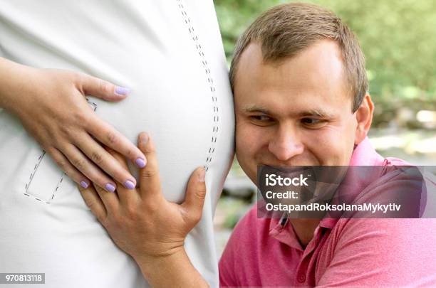 Handsome Man Is Listening To His Beautiful Pregnant Wifes Tummy Belly And Smiling Husband
