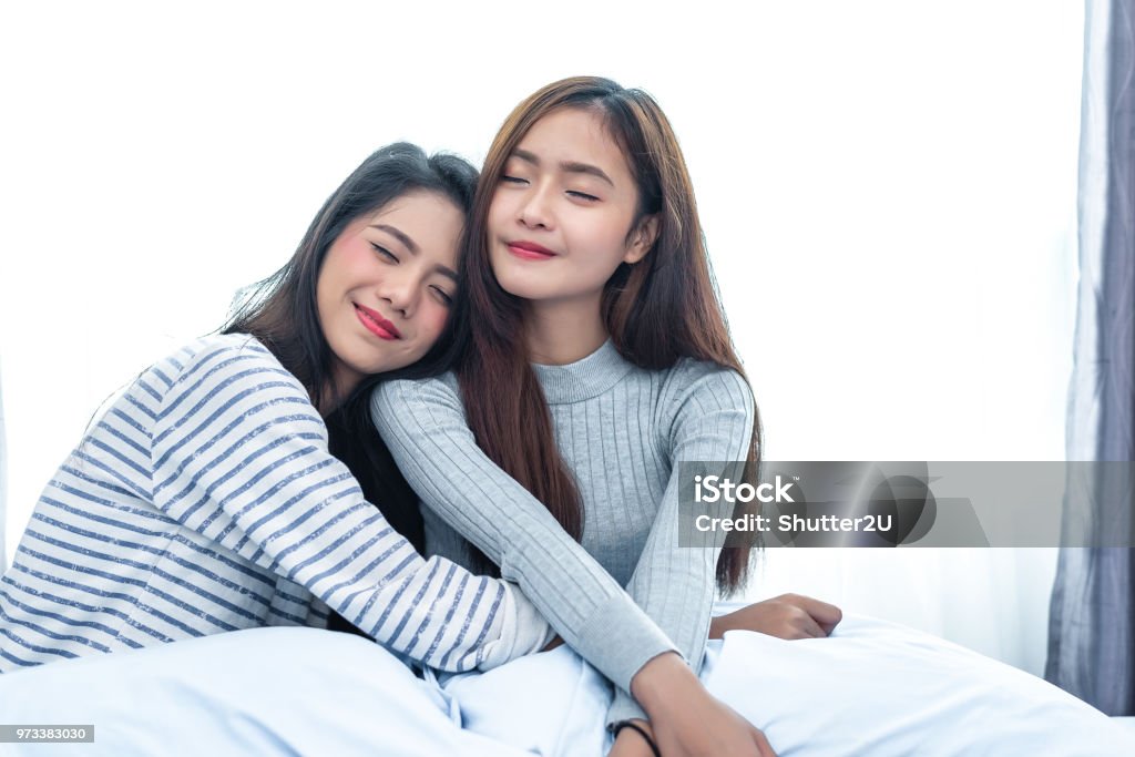 Two Asian Lesbian Women Hug Together In Bedroom Couple People And