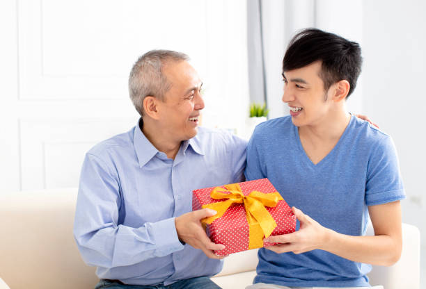 Free Stock Photo of Father s day concept - Son hold a gift box to give ...