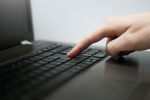 Close Up Photo Of A Mans Finger Pressing Button On Laptop Keyboard ... Close Up Photo Of A Mans Finger Pressing Button On Laptop Keyboard ...