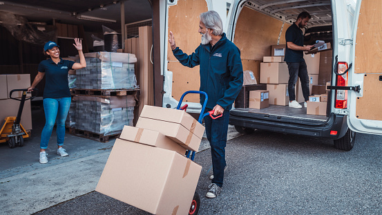 Coworkers Rushing To Load Packages In A Delivery Van Stock Photo ... Coworkers Rushing To Load Packages In A Delivery Van Stock Photo ...