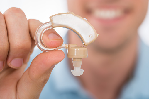 Man Holding Hearing Aid Stock Photo - Download Image Now - iStock Man Holding Hearing Aid Stock Photo - Download Image Now - iStock