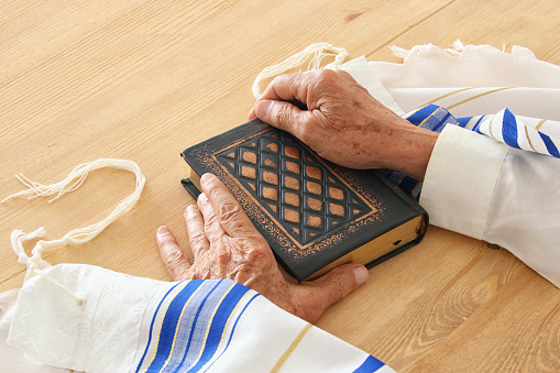 Old Jewish Man Hands Holding A Prayer Book Praying Next To Tallit ... Old Jewish Man Hands Holding A Prayer Book Praying Next To Tallit ...