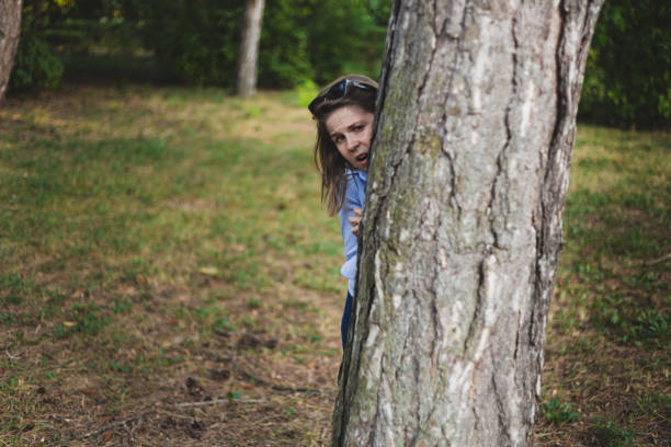 Dark Haired Woman Hiding Behind Tree Stock Photos, Pictures & Royalty ... Dark Haired Woman Hiding Behind Tree Stock Photos, Pictures & Royalty ...