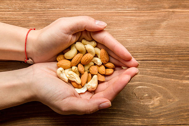 Handful Of Nuts Stock Photos, Pictures & Royalty-Free Images - iStock Handful Of Nuts Stock Photos, Pictures & Royalty-Free Images - iStock